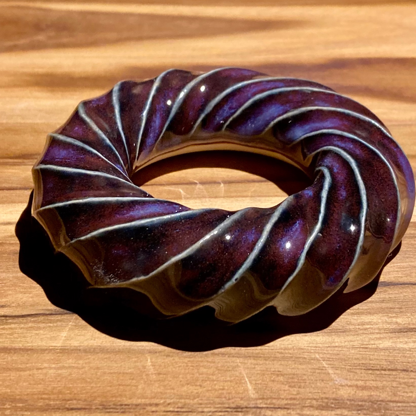 Smokey Merlot over Obsidian on texture | glazeshare